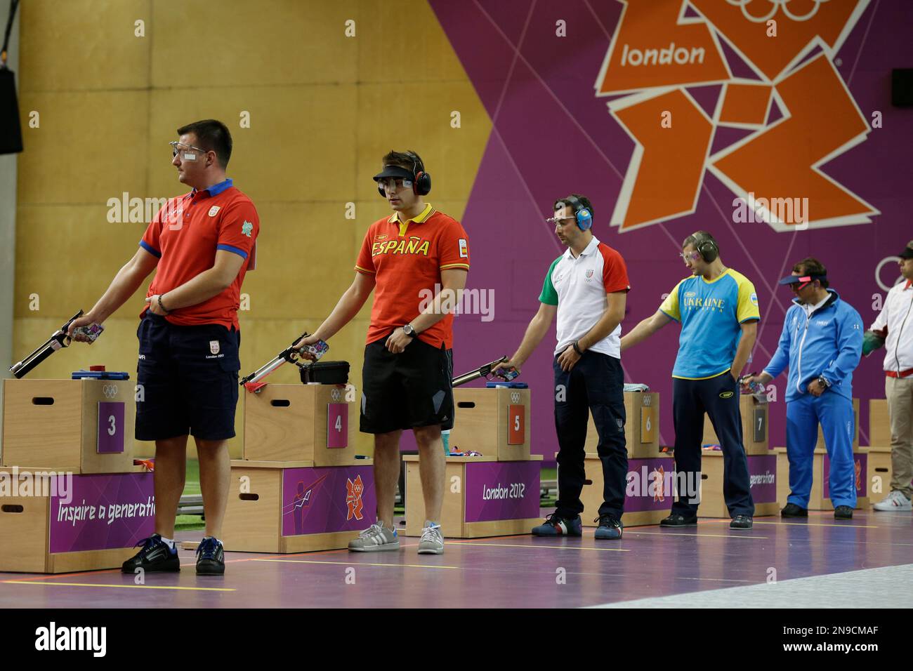 Competitors focus between shots during the men's10-meter air pistol ...