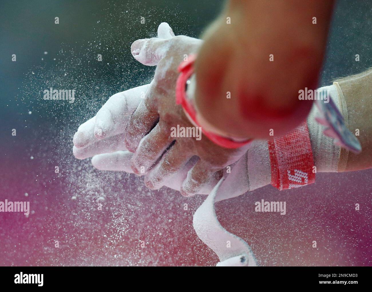 U.S. gymnast Samuel Mikulak chalks his hands during the Artistic ...
