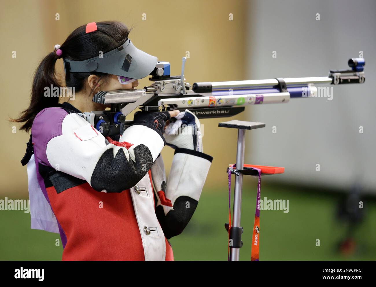 China's Yi Siling shoots during the women's 10-meter air rifle event at the 2012 Summer Olympics ...