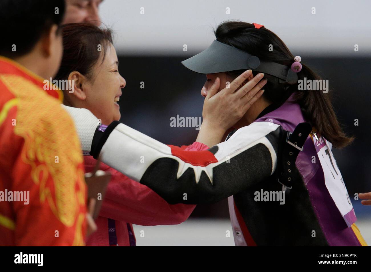 China's Yi Siling, right, is congratulated by her coach after winning the gold medal in the ...