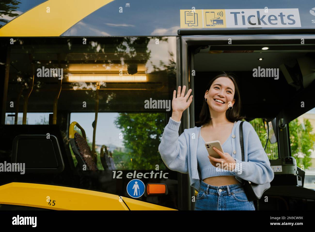 Woman waving bus hi-res stock photography and images - Alamy