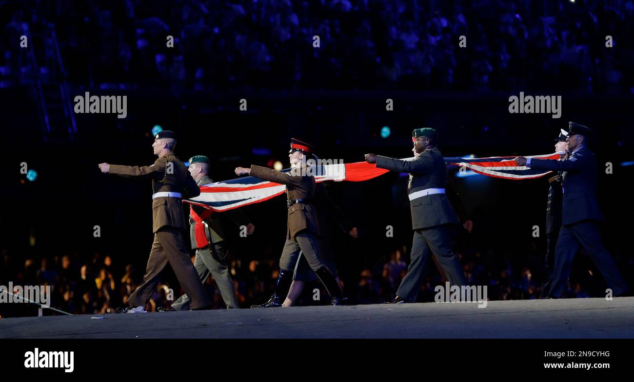 The British flag is carried in during the Opening Ceremony at the 2012 ...
