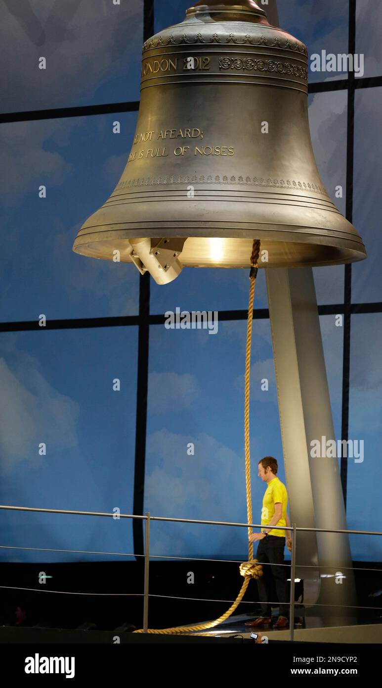 Tour de France champion Bradley Wiggins rings the Olympic Bell during ...