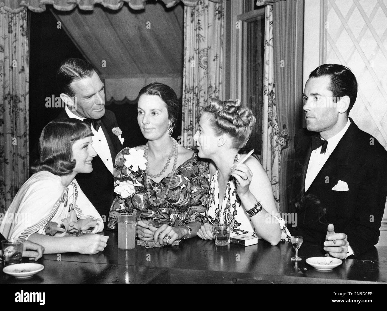 A party of screen and society types enjoy the antics of the Tailwaggers ...