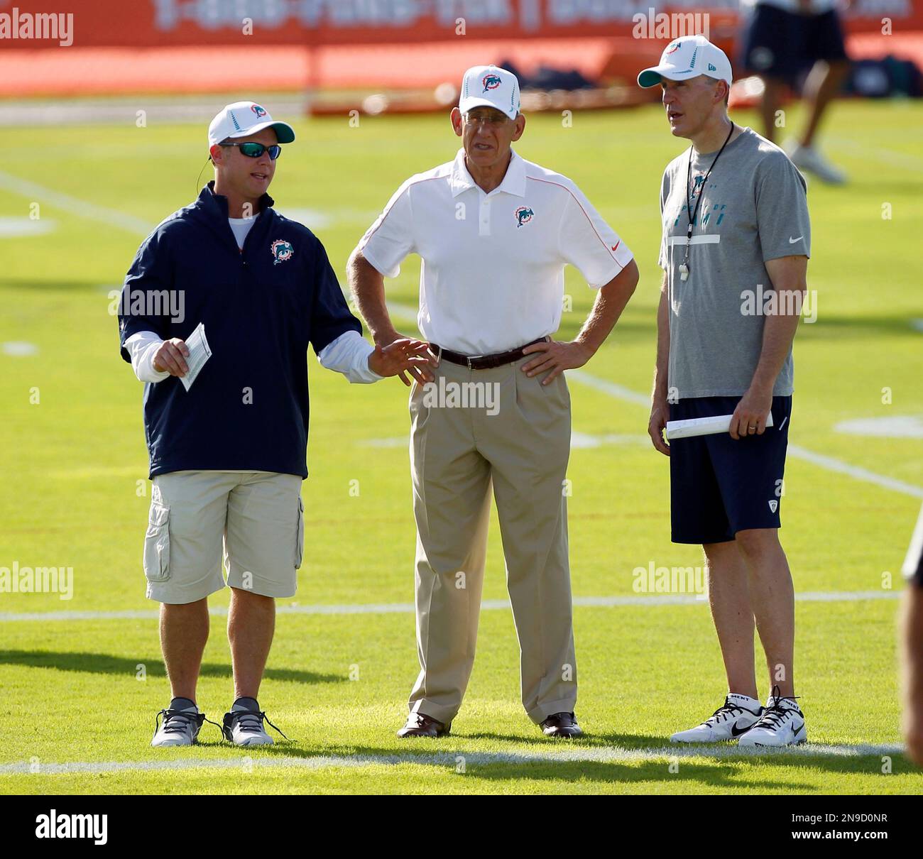 Miami Dolphins general manager Jeff Ireland, left, gestures as he talks ...