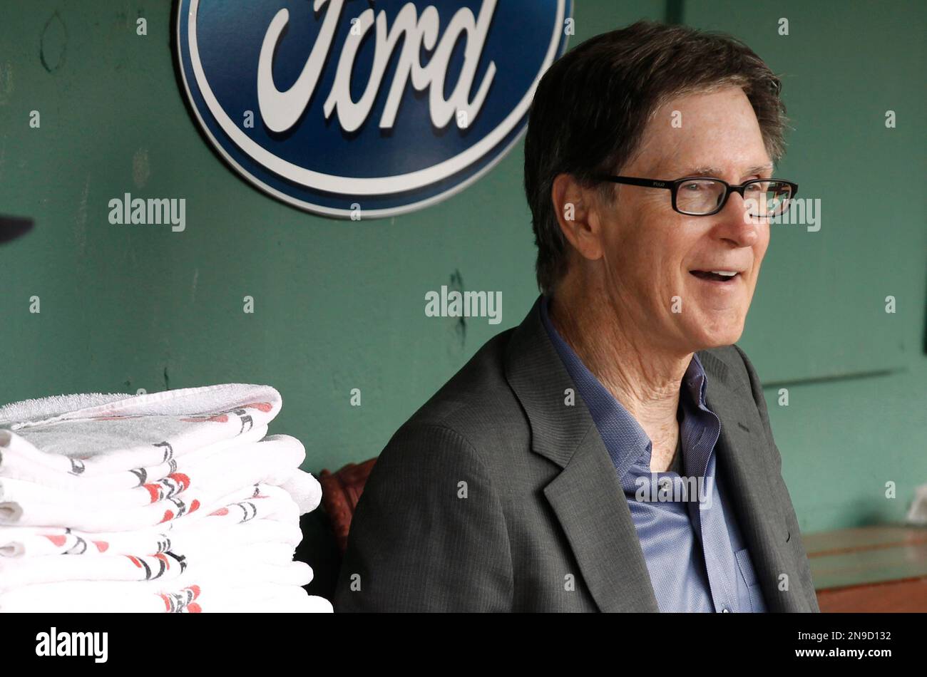Boston Red Sox owner John Henry sits in the dugout prior to baseball ...