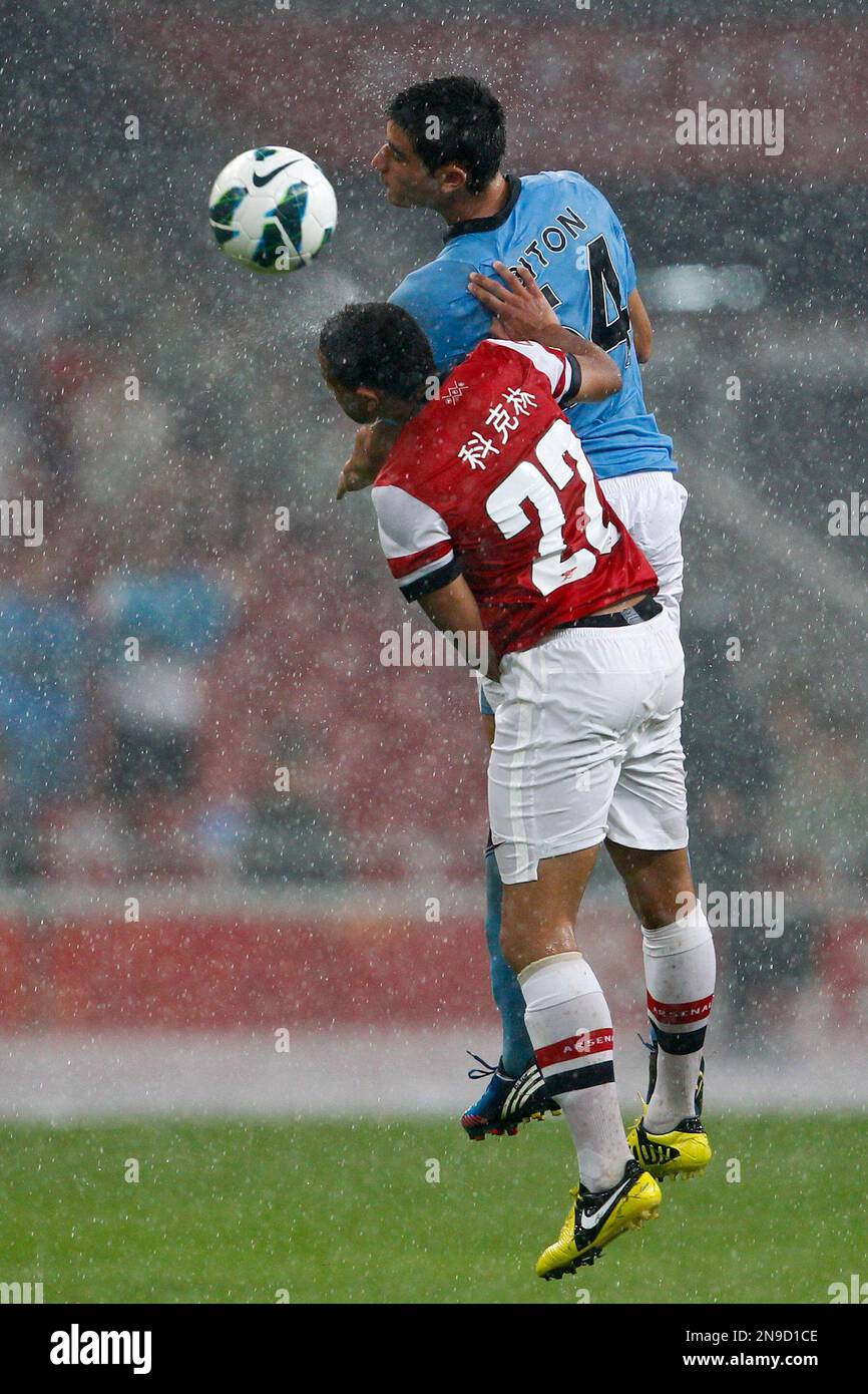 Manchester City's Nir Biton, top, heads the ball against Arsenal's ...