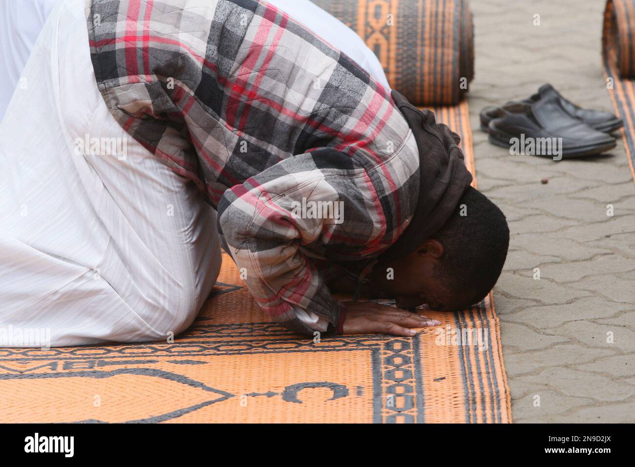 A Muslim man prays during the first Friday of Muslim holy fasting month ...