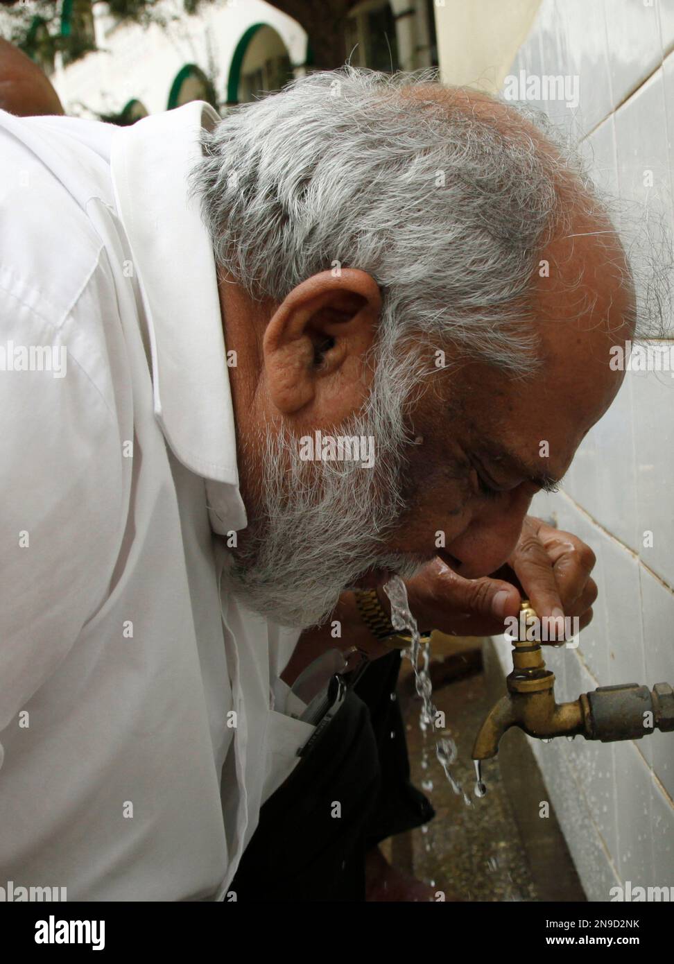 A Muslim man perform ablution before the prayers during first Friday of ...