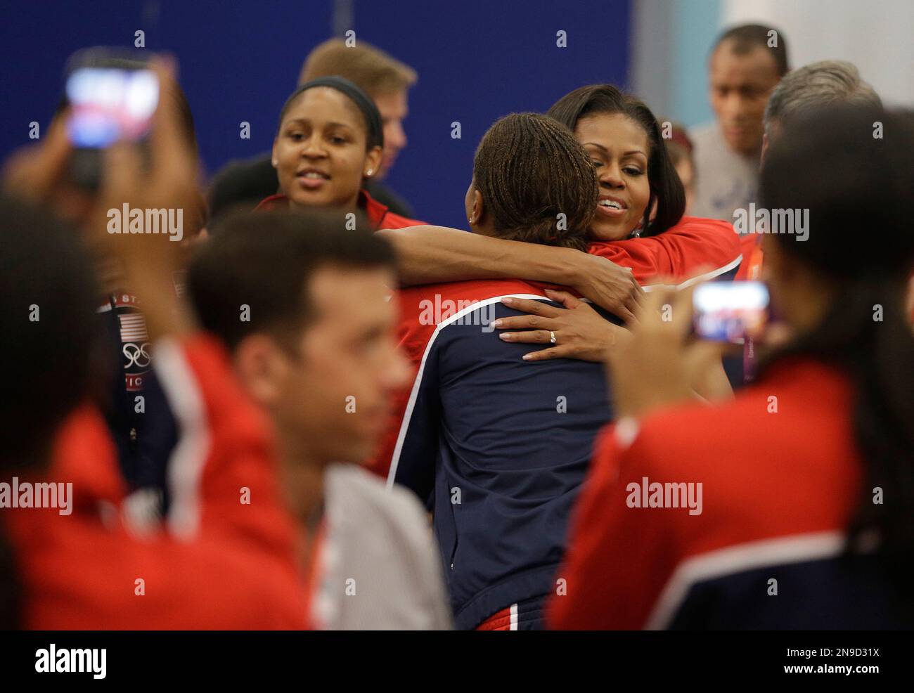 First lady Michelle Obama hugs basketball player Tamika Catchings after ...