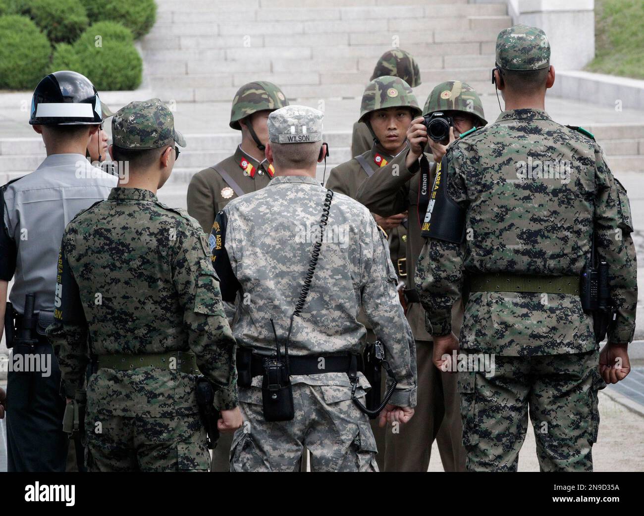 A North Korean solider takes pictures as a U.S., center, and South ...