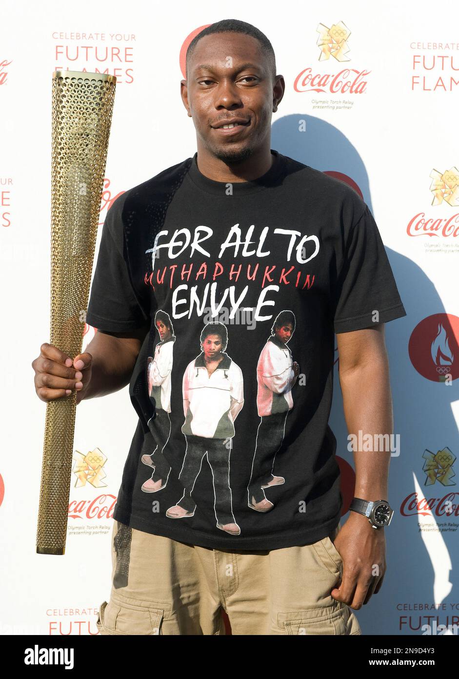 British singer Dizzee Rascal holds the Olympic Torch before he performs ...
