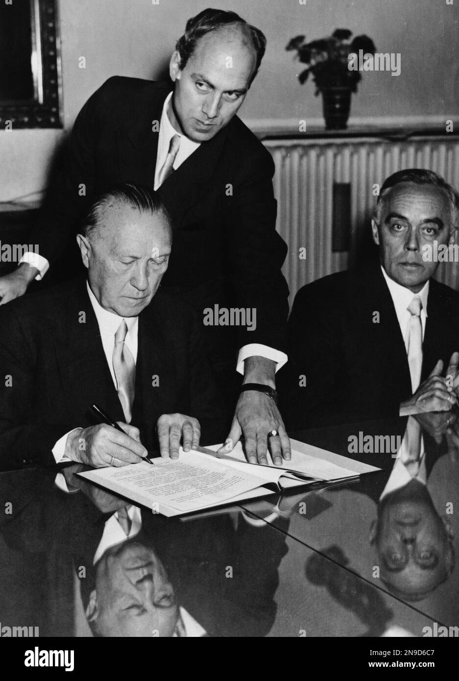 West German Chancellor Konrad Adenauer signs agreements providing ...