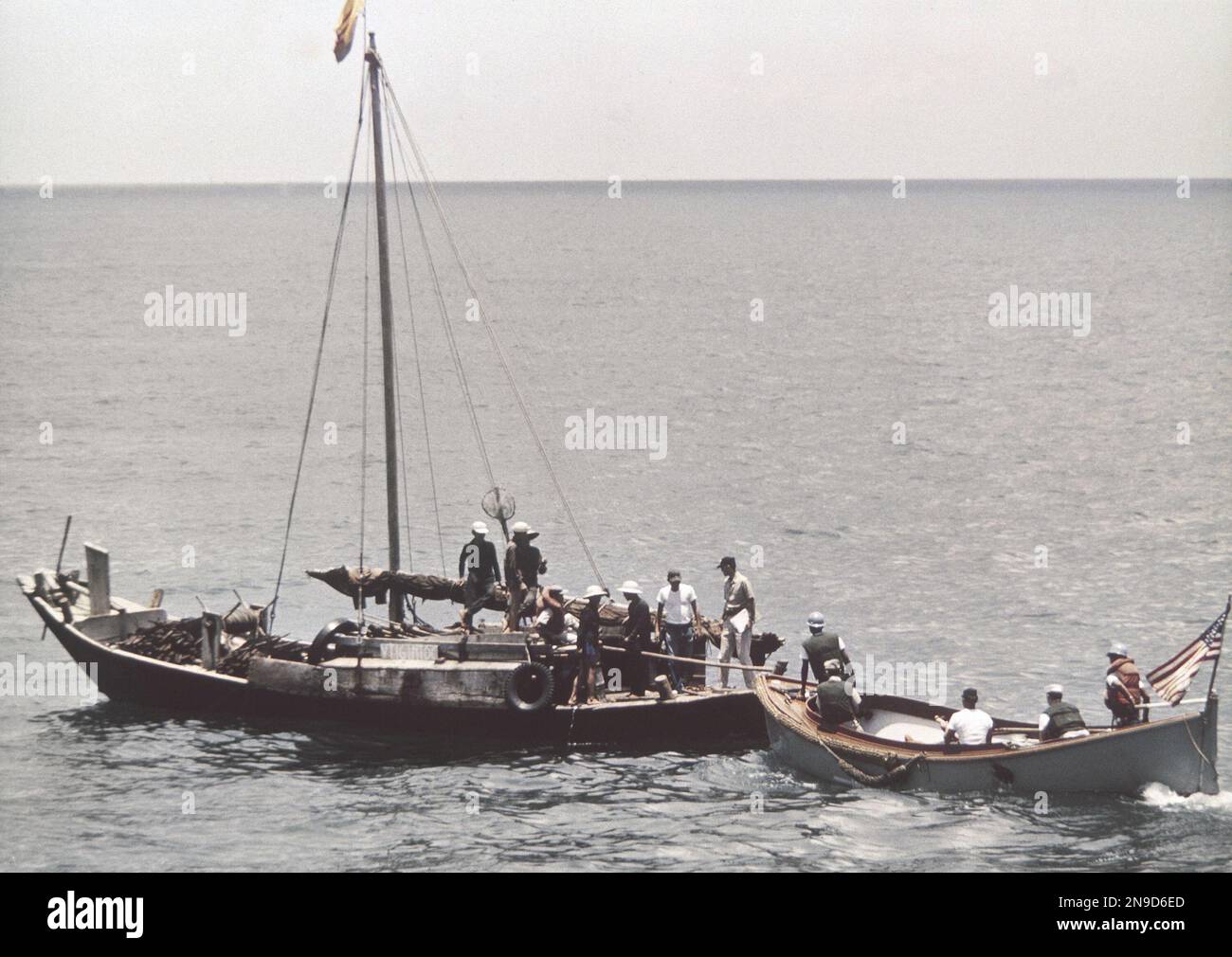 Crewmembers of fishing junk display a sign to warn U.S. Navy and ...