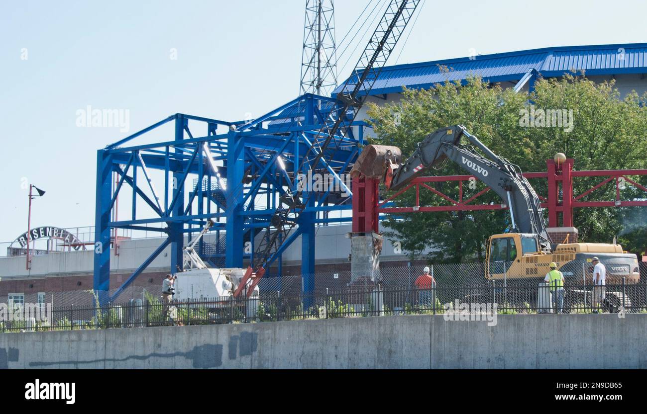 Heavy equipment tears into the front of Rosenblatt Stadium, the former ...
