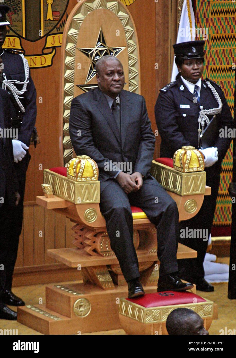 Ghana Vice President John Mahama, center, sits on a chair after being ...