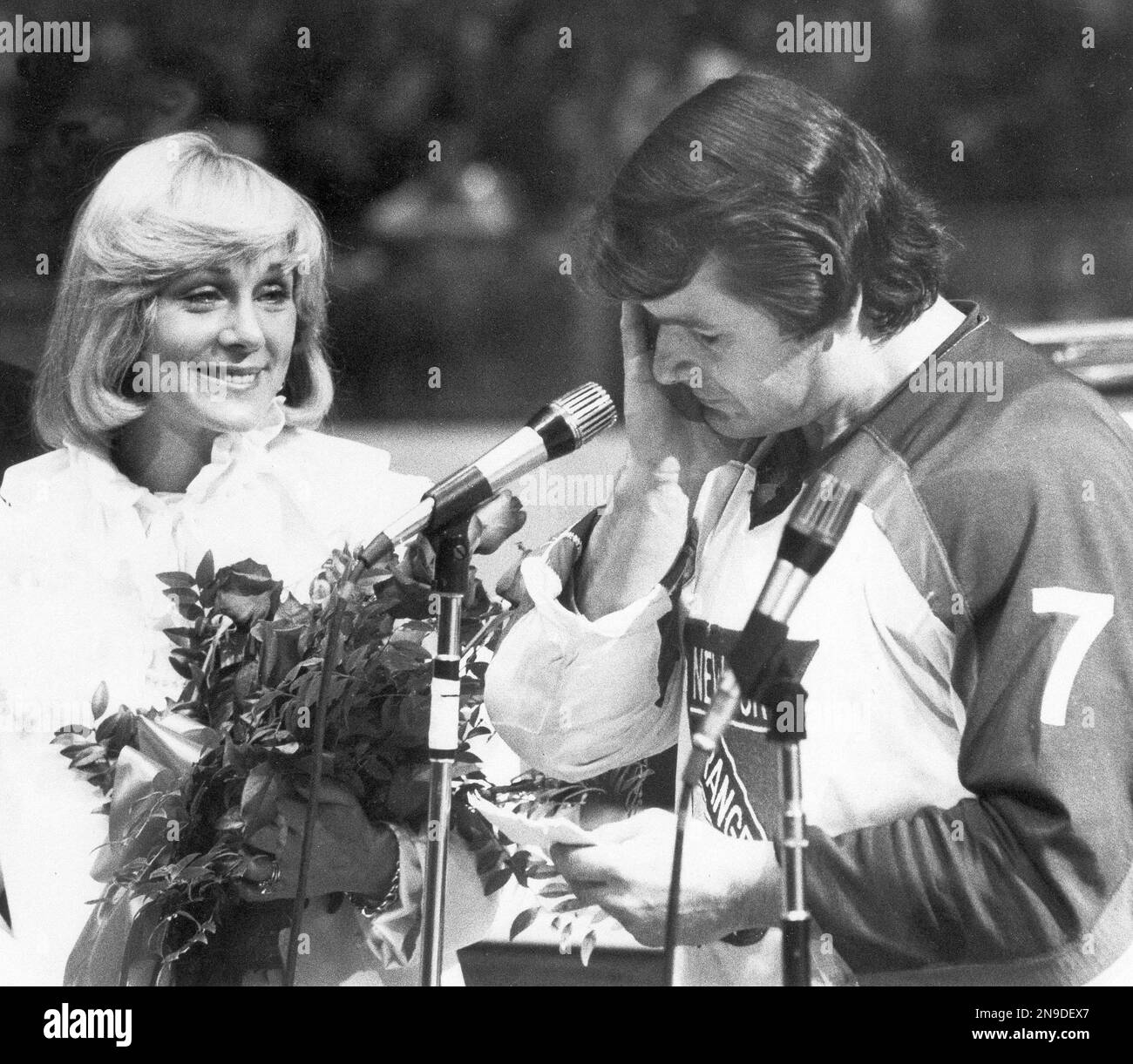 Rod Gilbert wipes his eye as his wife Judy stands by holding a bouquet ...