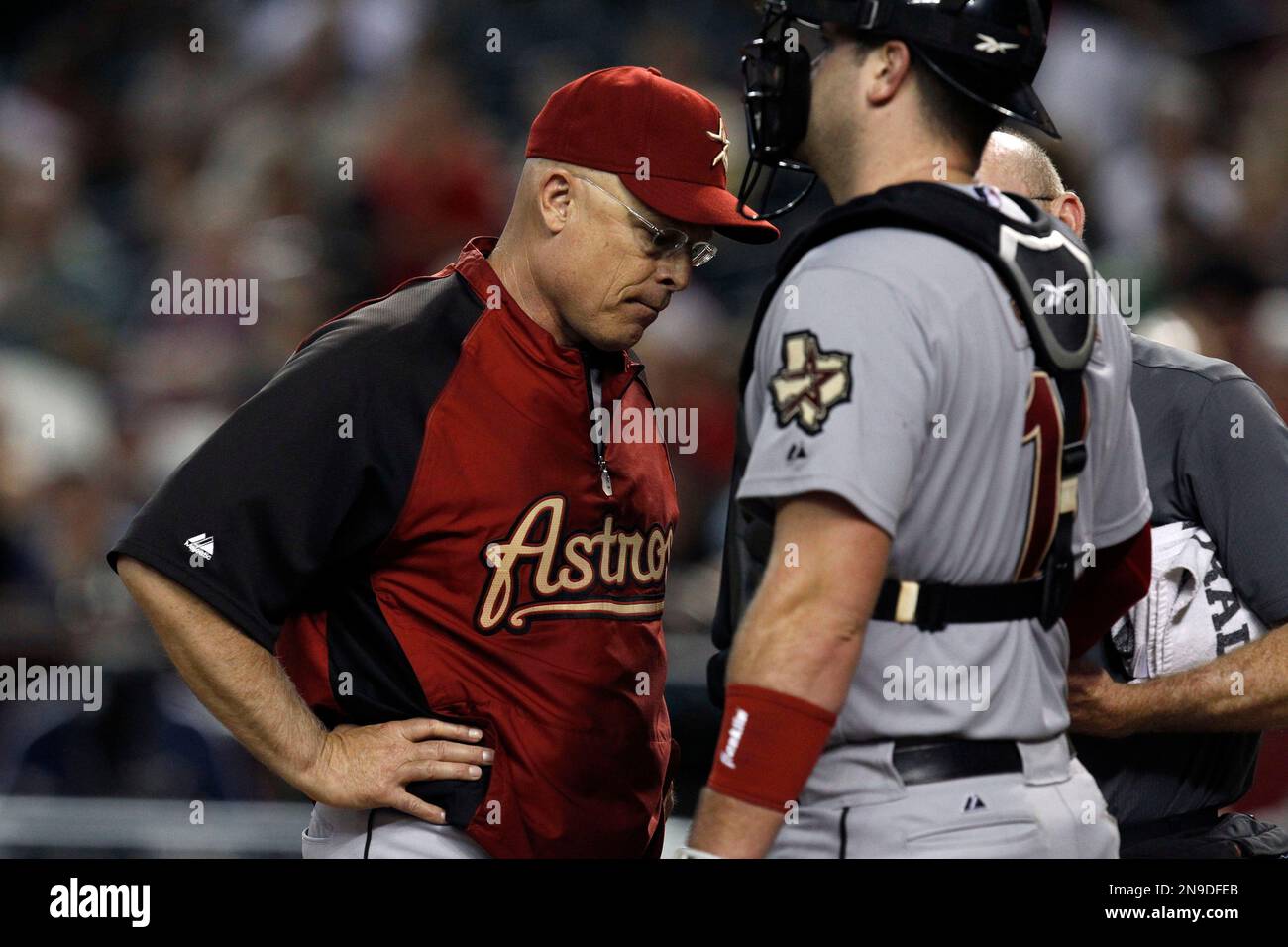 Houston Astros' Brad Mills, left, check out his catcher Chris Snyder ...