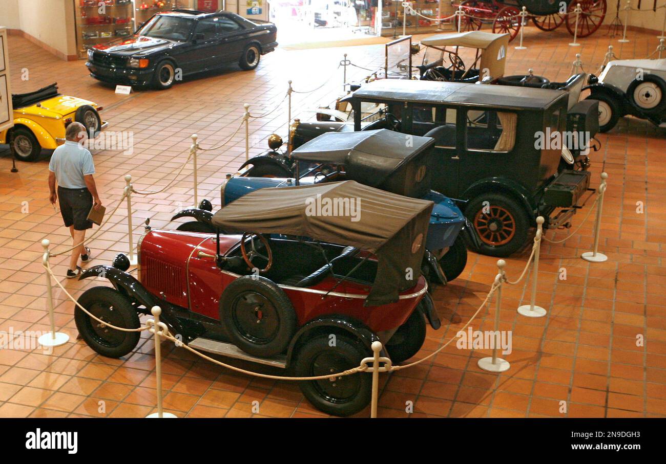 A visitor looks at the cars of the collection of Prince Albert II of ...