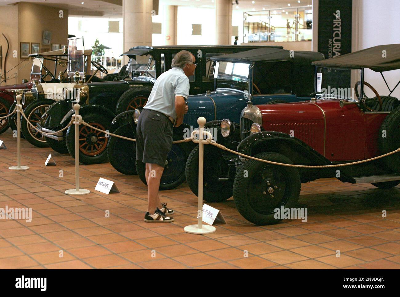 A visitor looks at the cars of the collection of Prince Albert II of ...