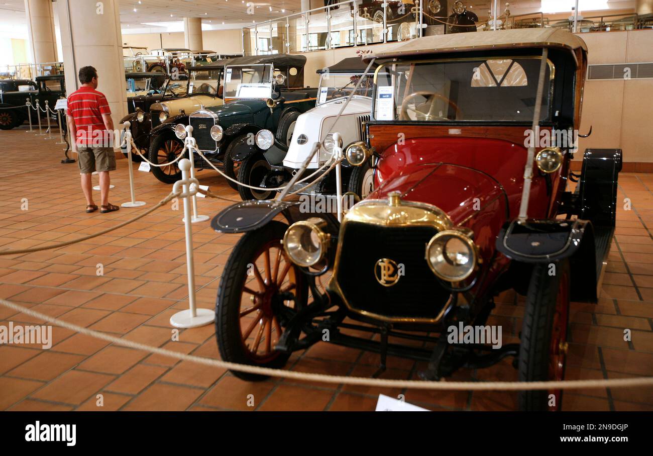 A visitor looks at the cars of the collection of Prince Albert II of ...