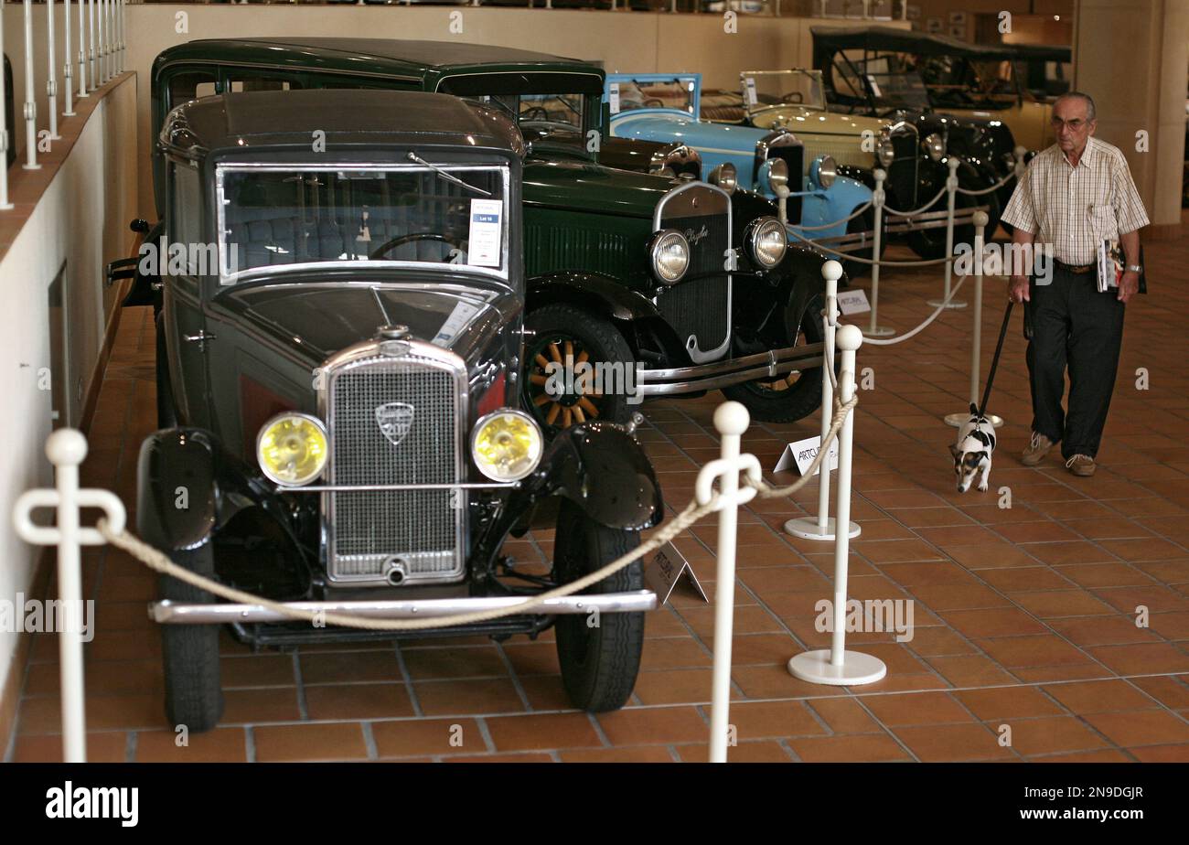 A visitor looks at the cars of the collection of Prince Albert II of ...
