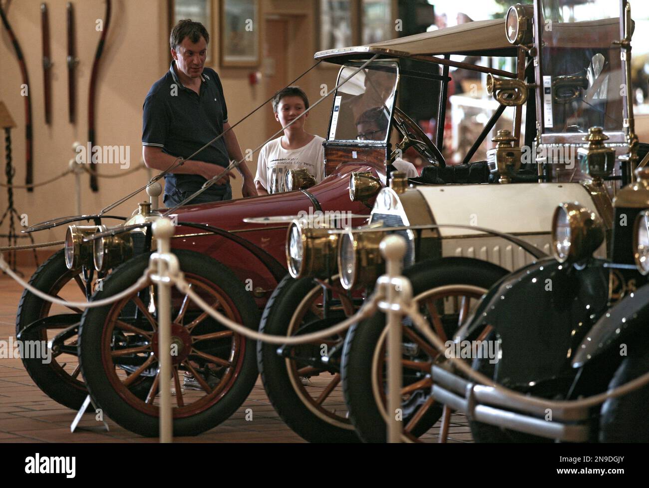 Visitors look at the cars of the collection of Prince Albert II of ...