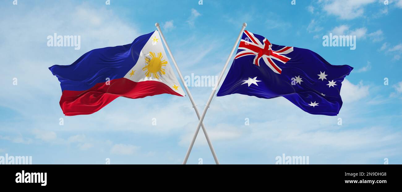 two crossed flags Australia and Philippines waving in wind at cloudy ...