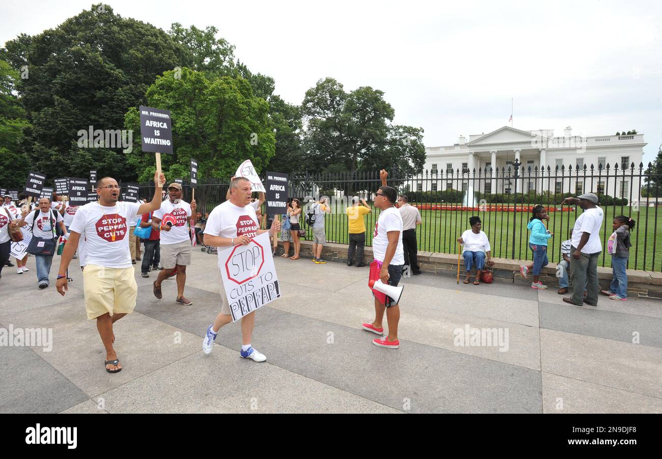 Protesters march with signs during the Global AIDS Funding Protest ...