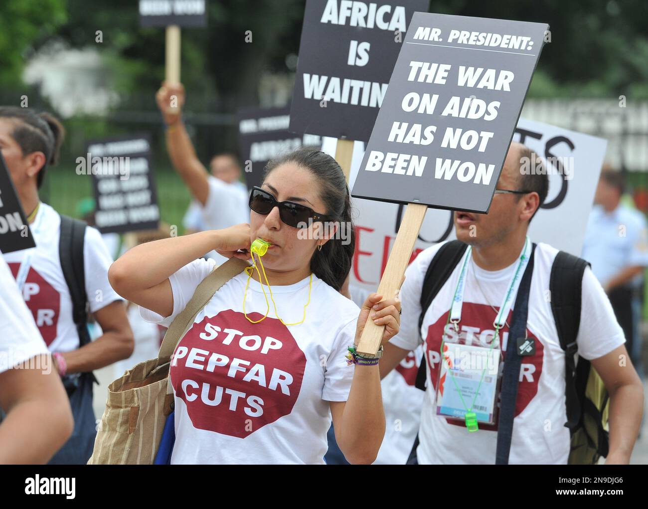 Protesters march with signs during the Global AIDS Funding Protest ...