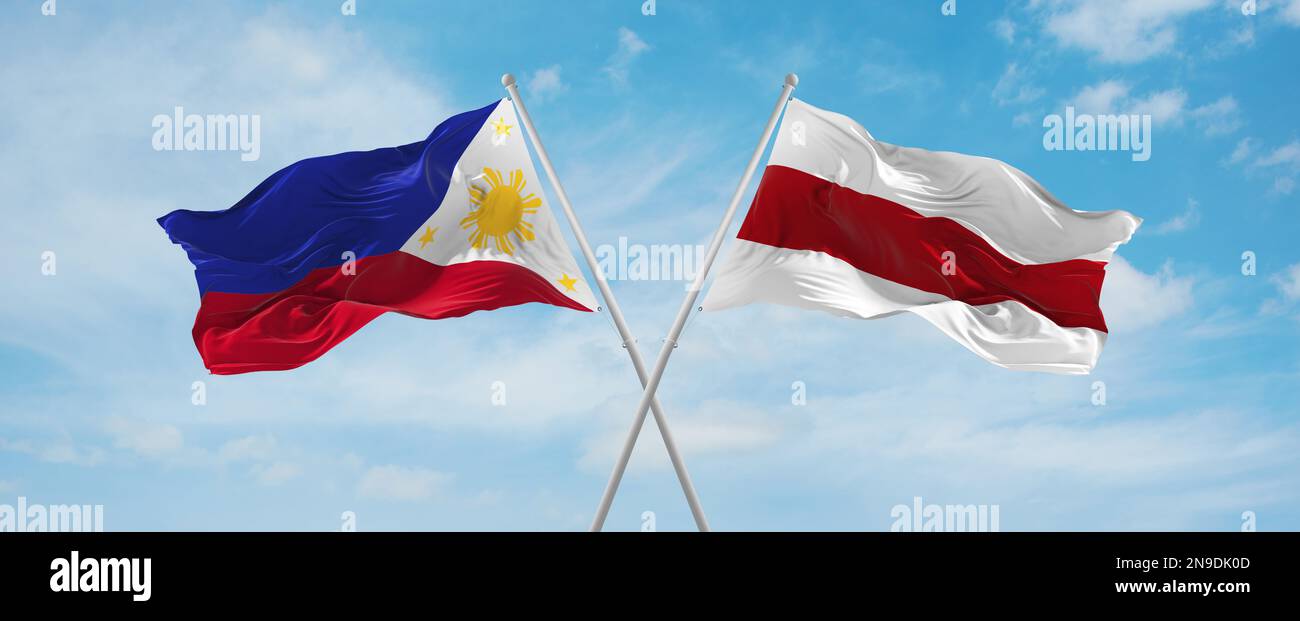 two crossed flags Belarus and Philippines waving in wind at cloudy sky ...