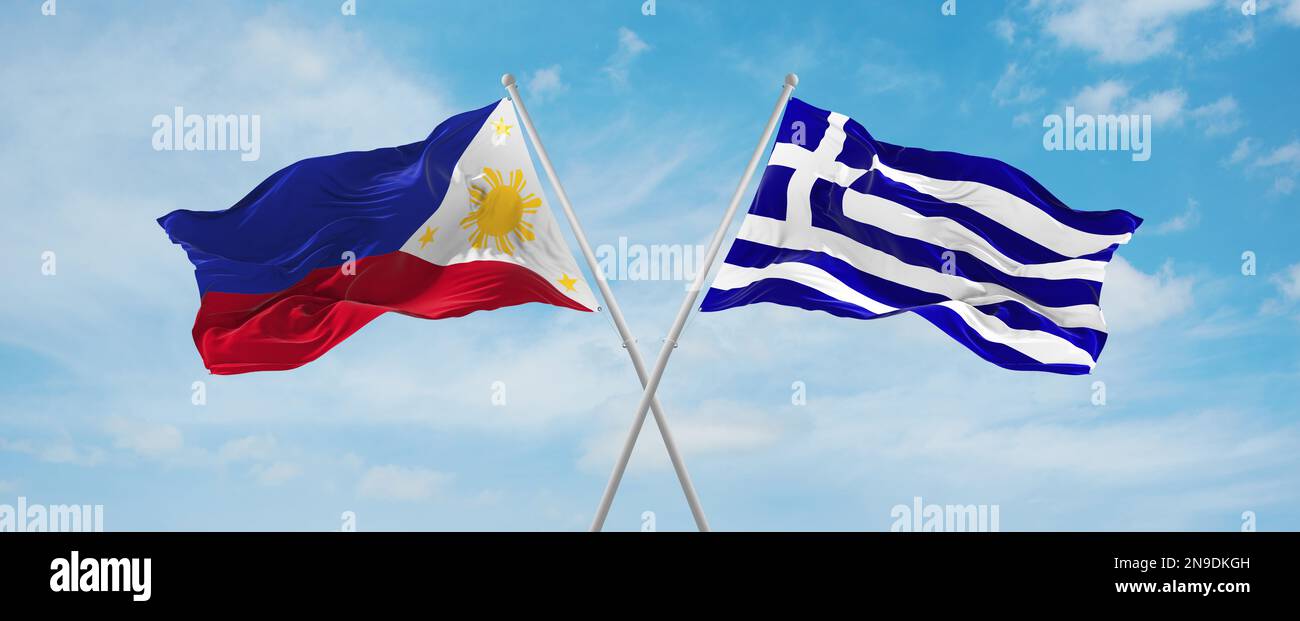 two crossed flags Greece and Philippines waving in wind at cloudy sky ...