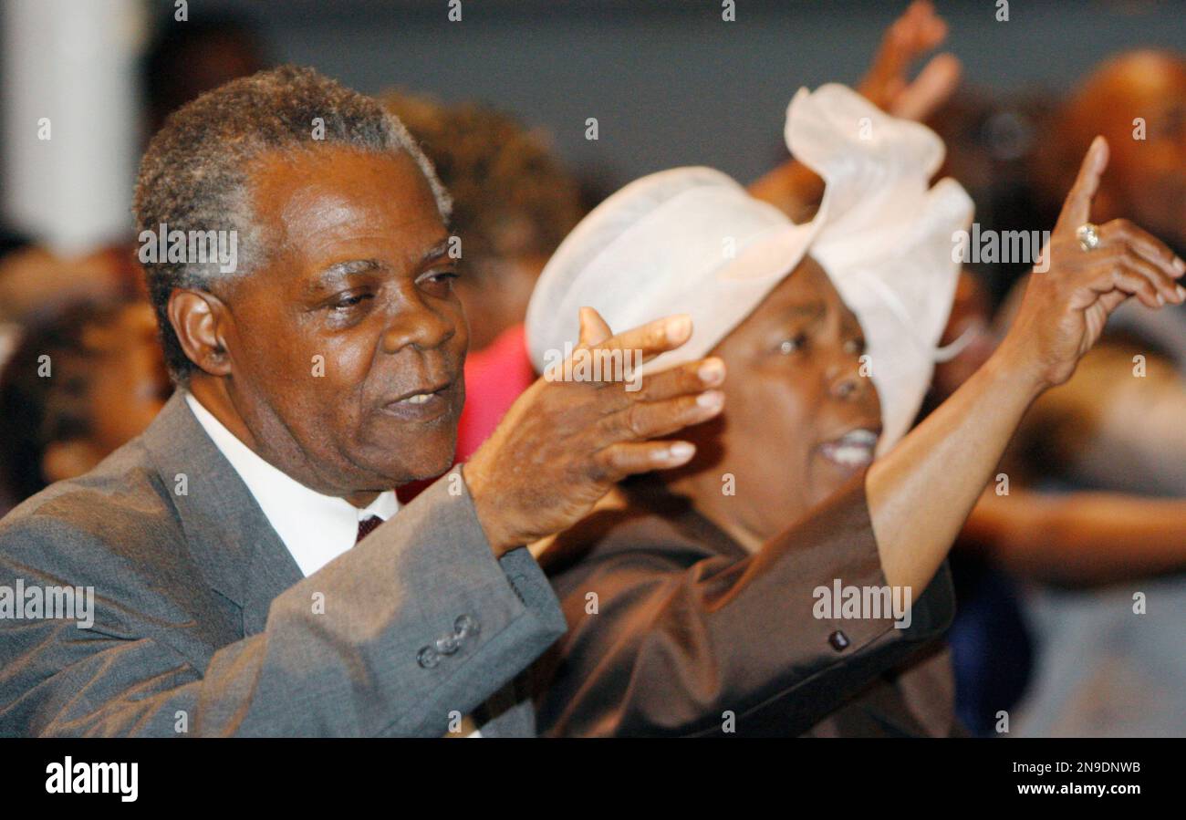 The Rev. Michel Louis, left, and his wife Gladys, join parishioners as ...