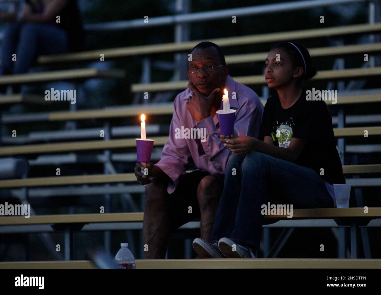 Two people attending a vigil for movie theater shooting victim AJ Boik ...