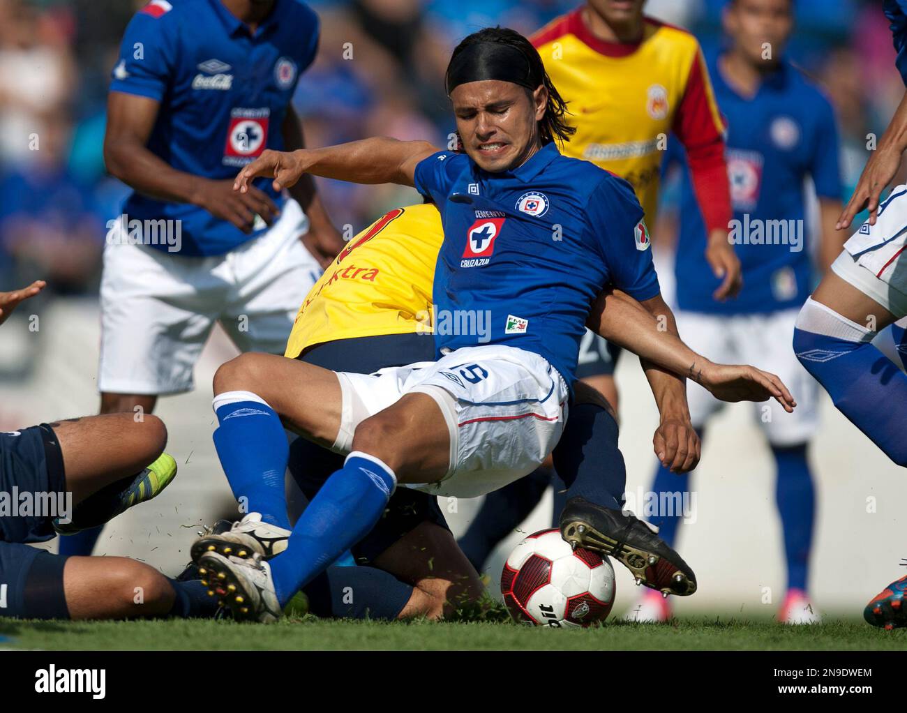 Cruz Azul's Gerardo Flores, top, fights for the ball with Mauricio ...
