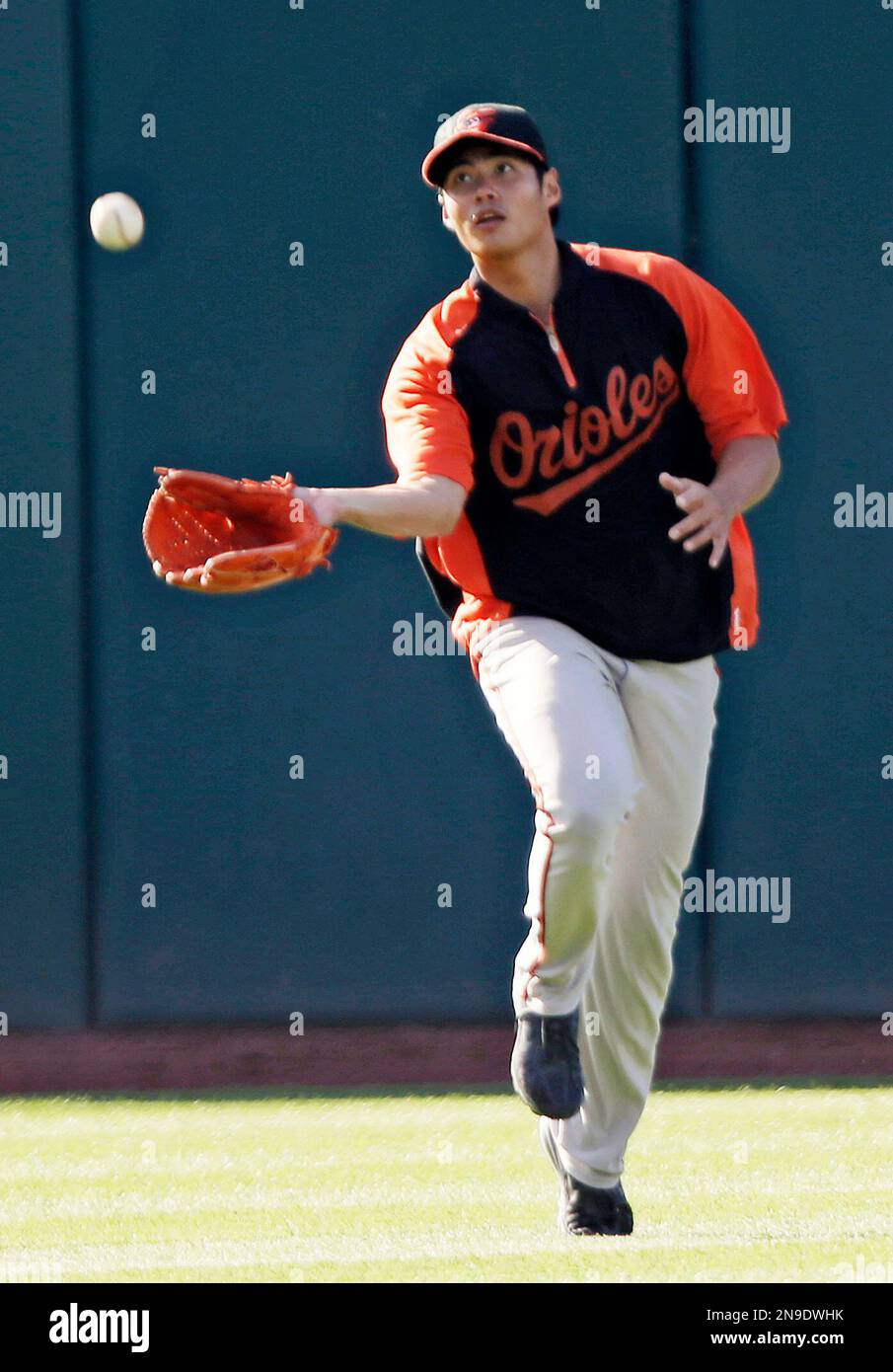 Baltimore Orioles pitcher Wei-Yin Chen, from Taiwan, shags fly balls ...
