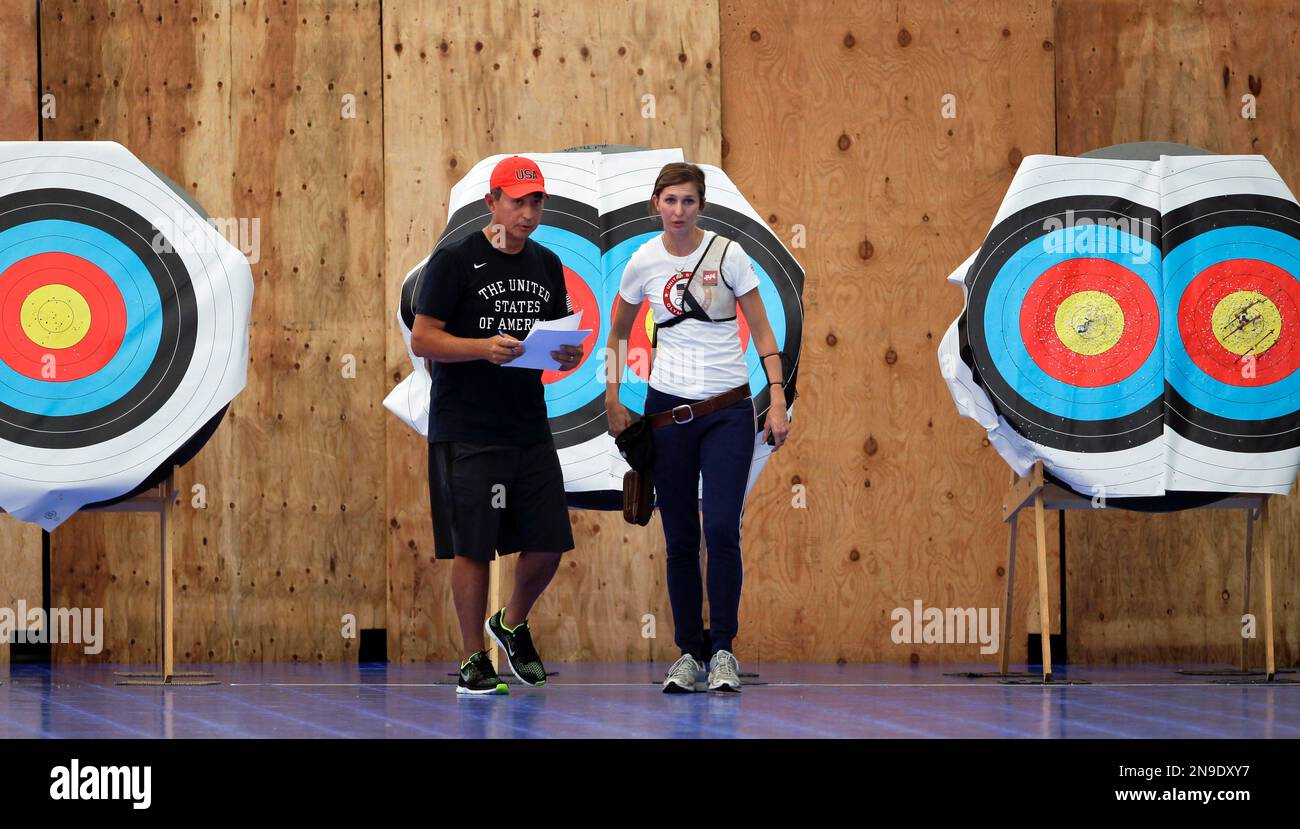 U.S. Olympic archer Jennifer Nichols, right, speaks to coach Mel ...