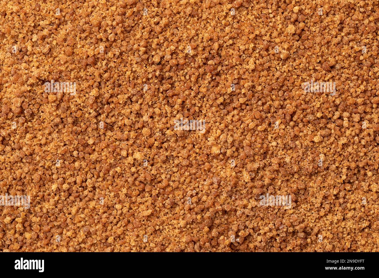 Golden palm sugar close up full frame as background Stock Photo - Alamy