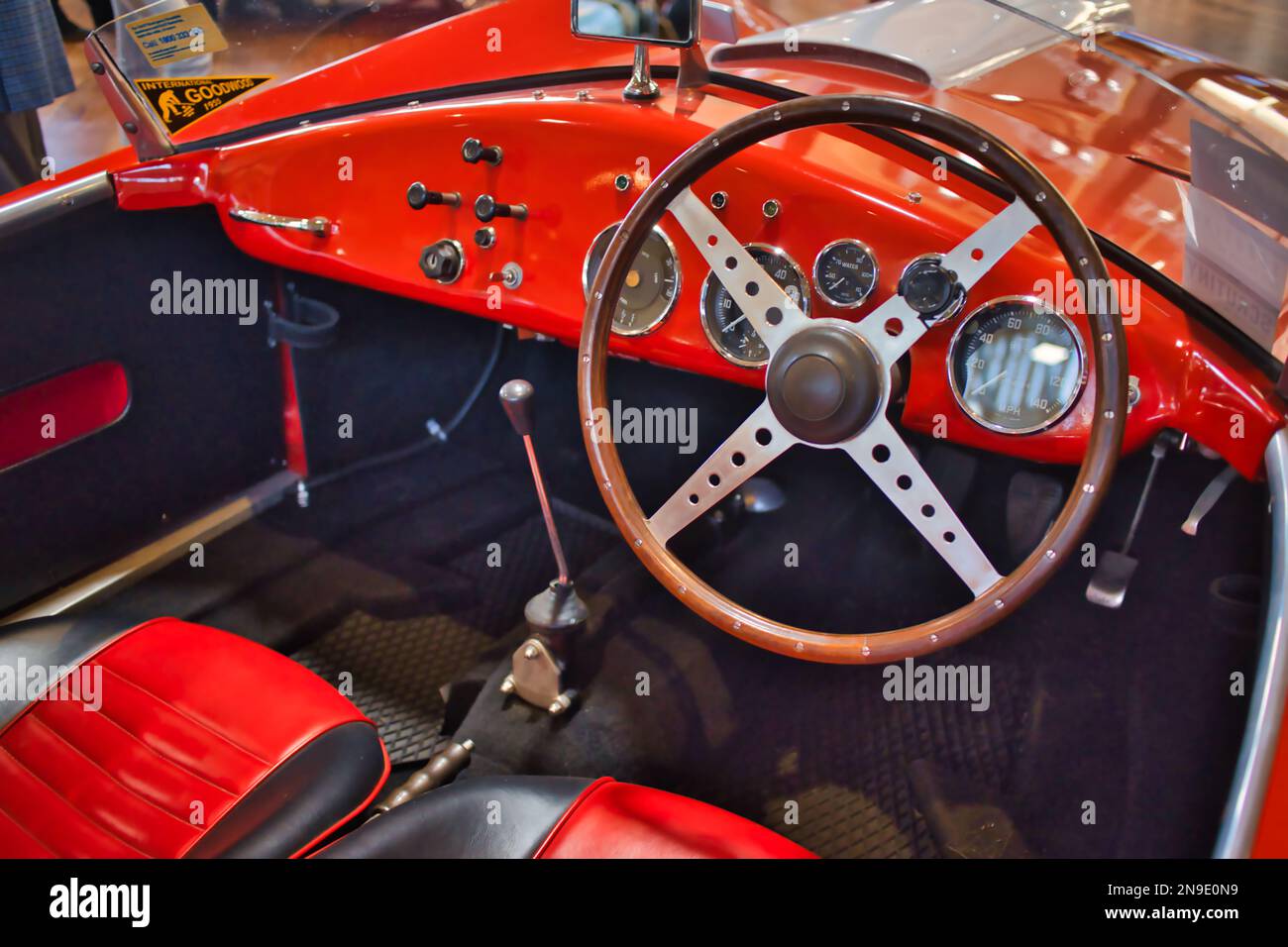 A close-up of the inside and the steering wheel of a red classic rally ...