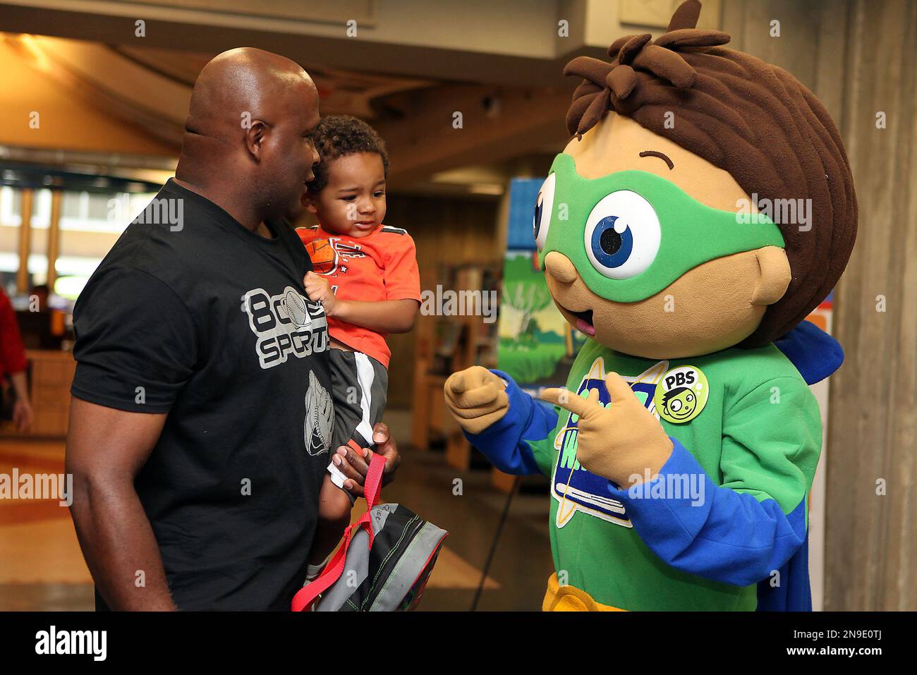 PBS KIDS mascot Super Why poses with a child during the Soar with ...