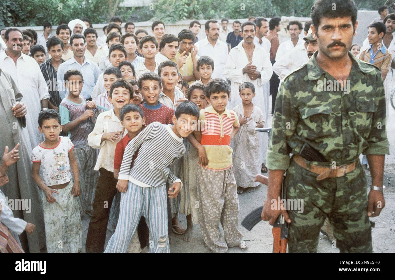 Iranian villagers surround an occupying sentry posted by an Iraqi armed ...