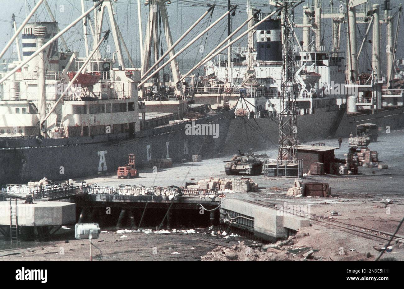 Tank of the occupying Iraqi armed forces is dwarfed by shipping on a ...