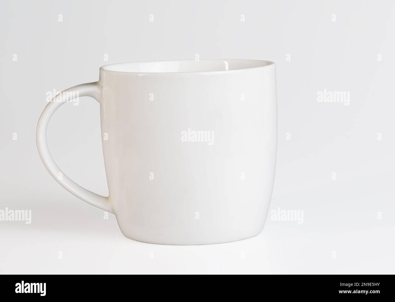 White cup on a white background. Side view. Mockup template Stock Photo ...