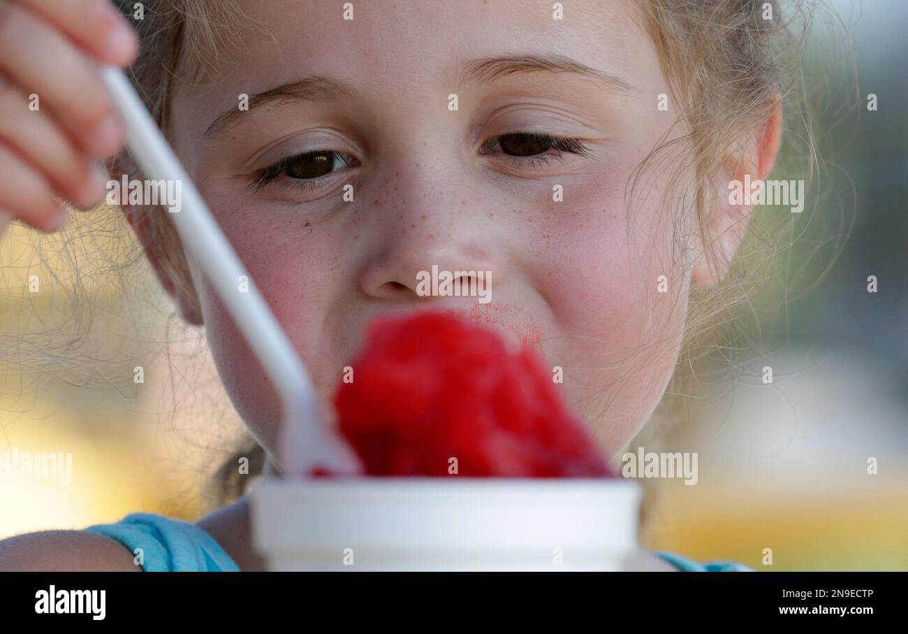 Amelia Ramalho, age 4, eats a strawberry-flavored snowball in Towson ...