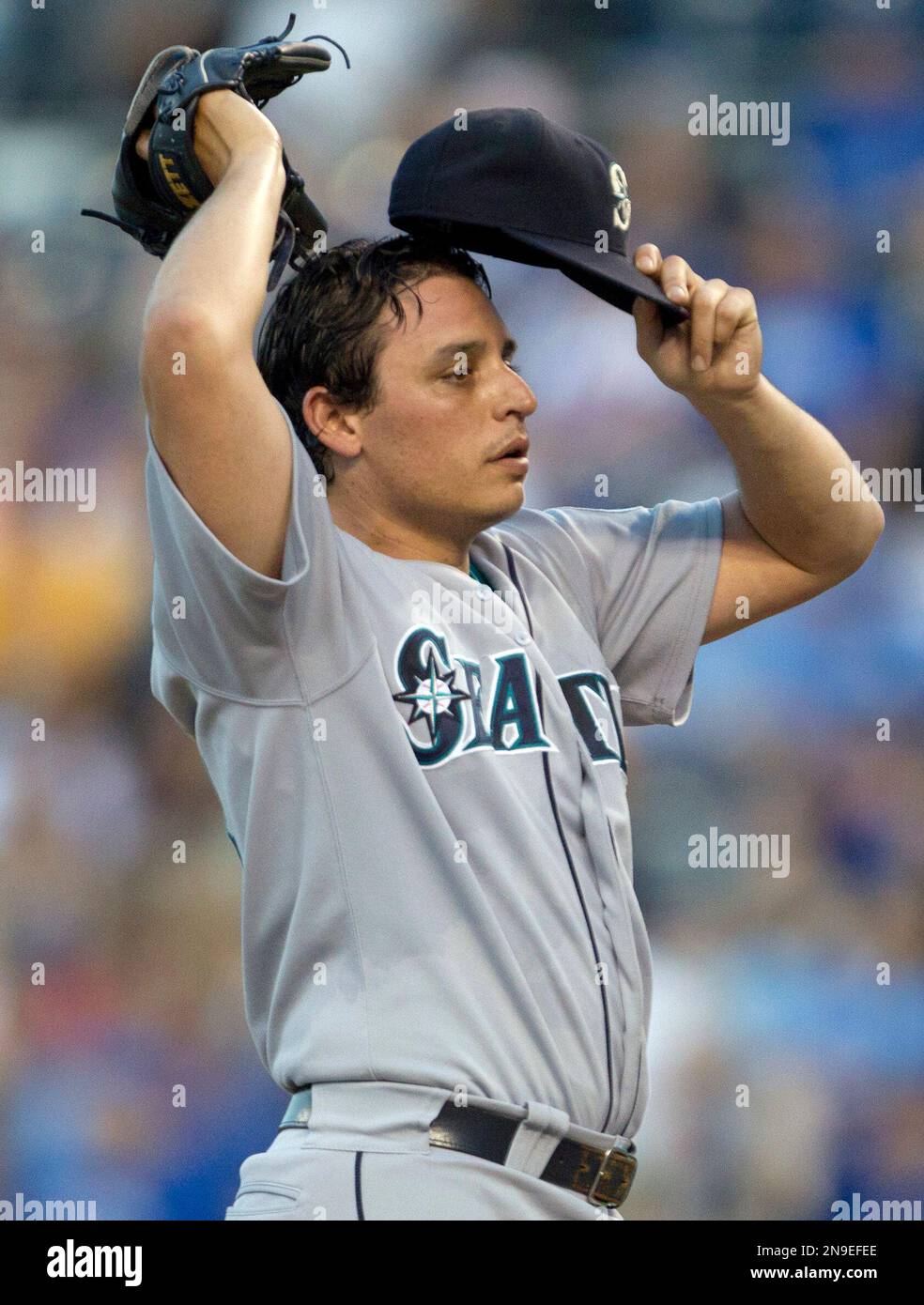 Seattle Mariners starting pitcher Jason Vargas adjusts his cap during ...