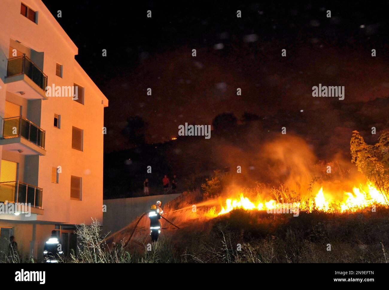 Firefighters battle a fire in Podgorica, Montenegro, early Tuesday ...