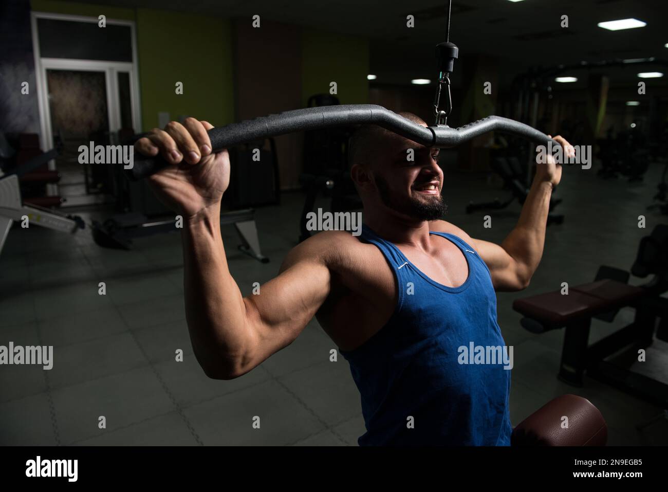 A Handsome Athlete Doing Heavy Weight Exercises Stock Photo - Alamy