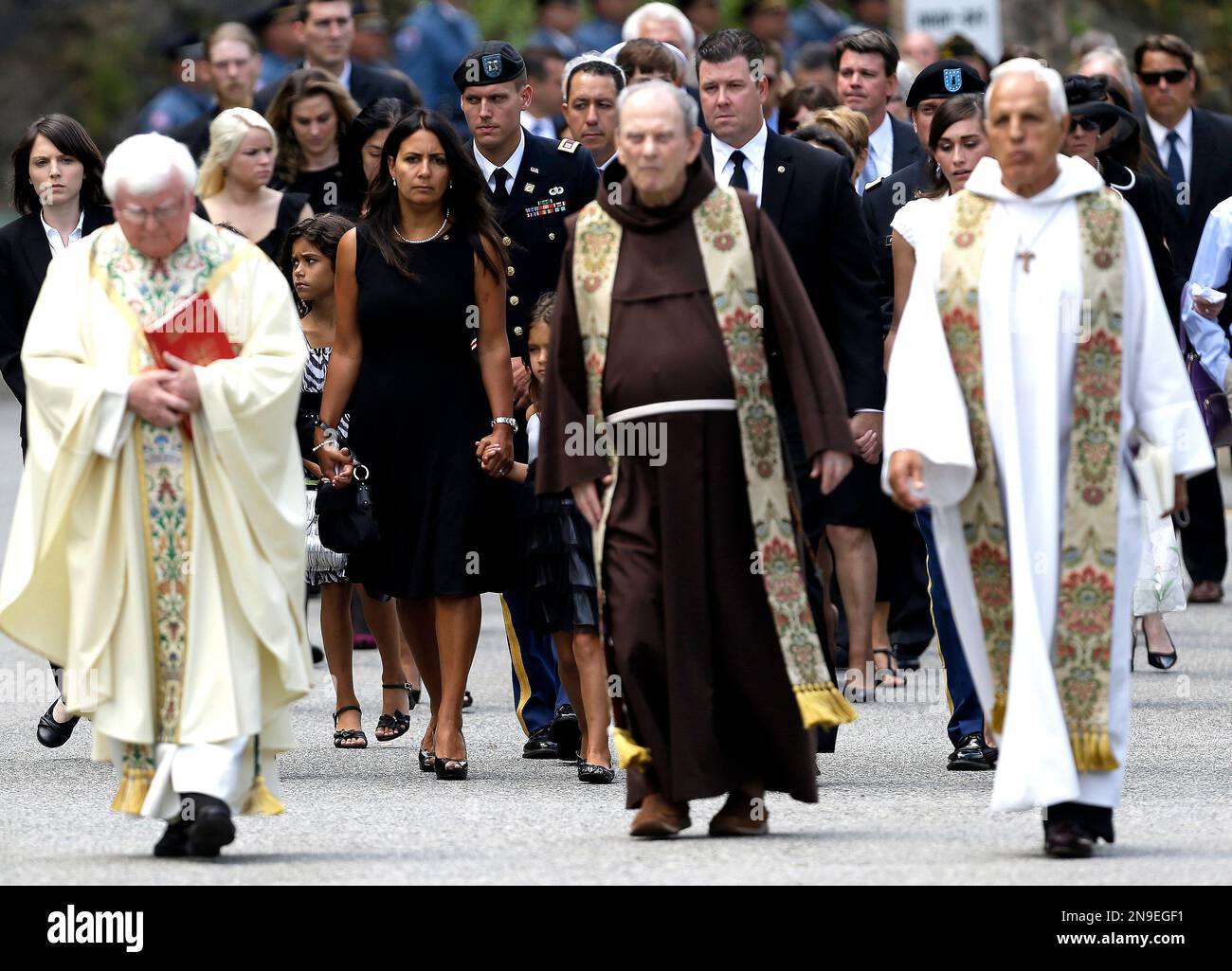 Jeannette Gaston, center left, walks with her husband Erik Gaston ...