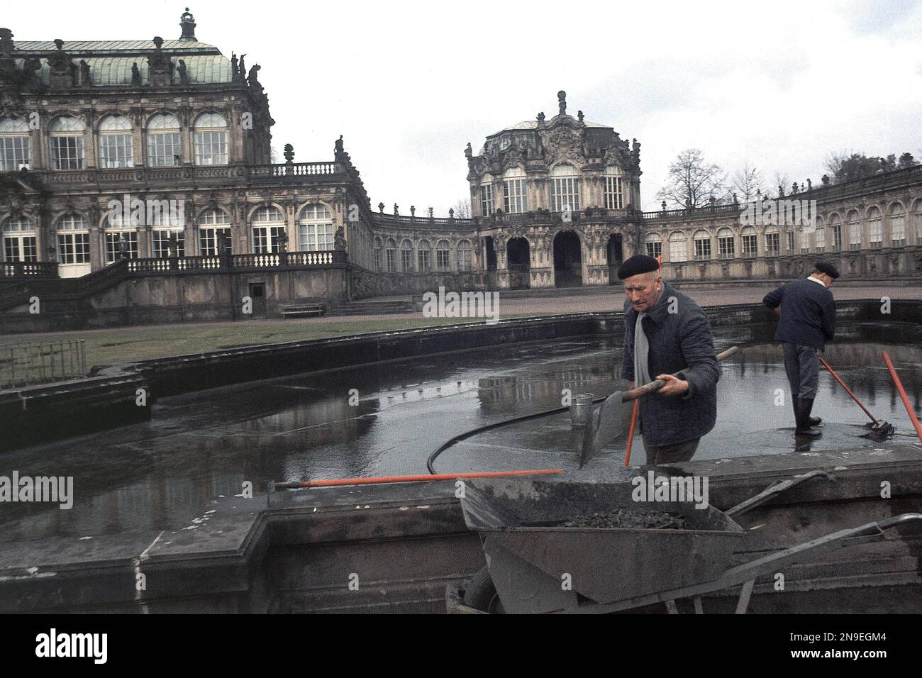 Workers clean the fountains of the completely restored Baroque Zwinger ...