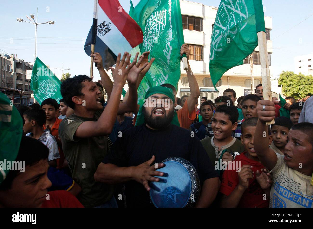 FILE - In a Sunday, June 24, 2012 file photo, Palestinians wave green ...